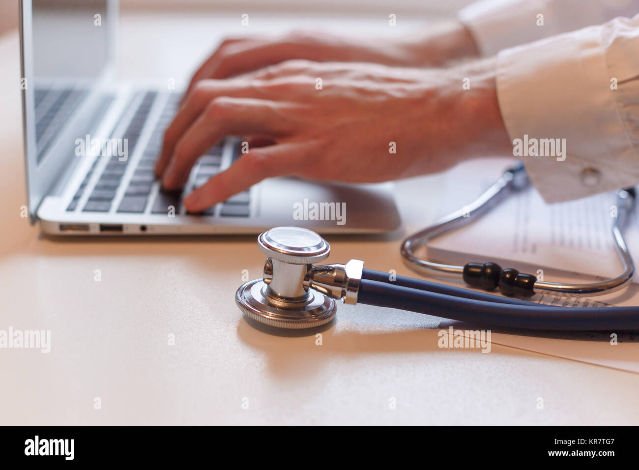 Doctor working with laptop computer in medical workspace office. Focus ...