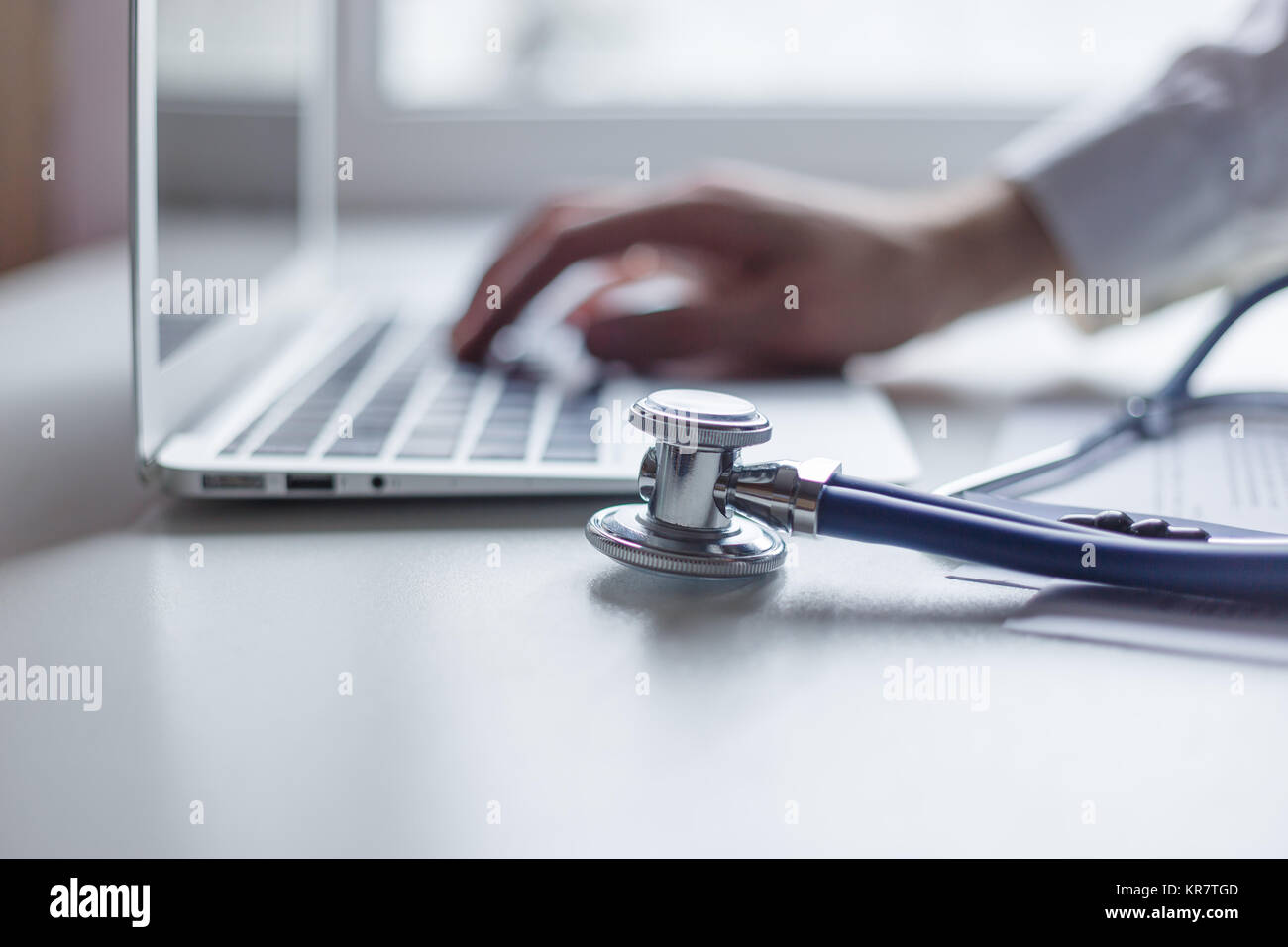 Doctor working with laptop computer in medical workspace office. Focus ...