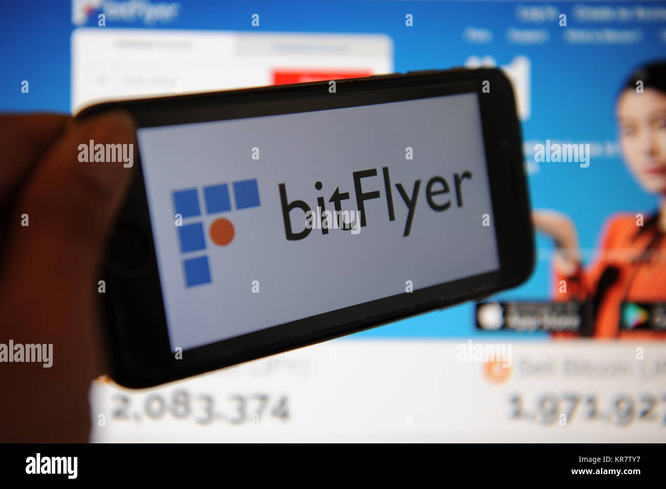 bitFlyer logo on a phone and the bitFlyer website on a computer screen Stock Photo - Alamy