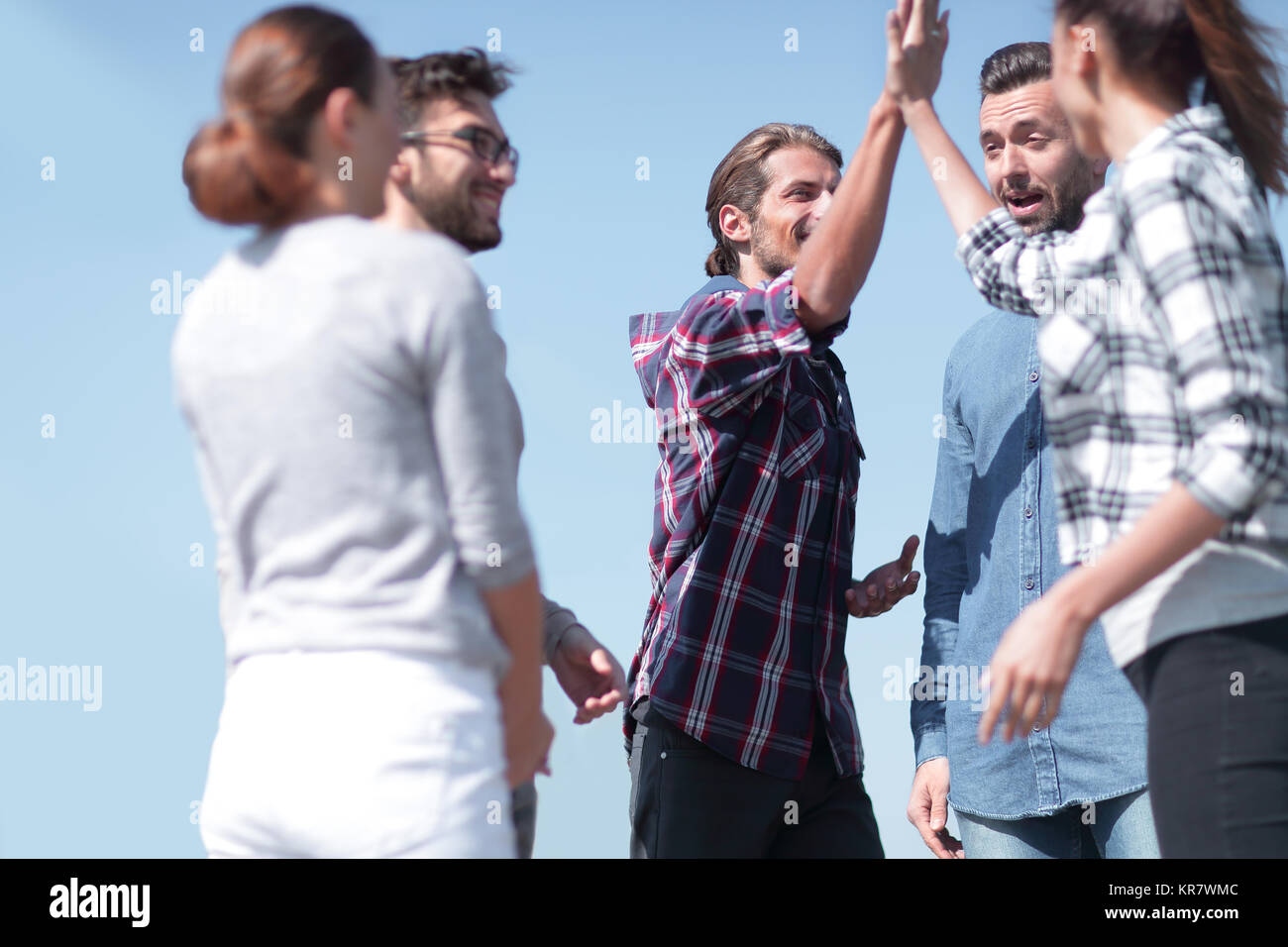 friends greet each other, giving a high five Stock Photo - Alamy
