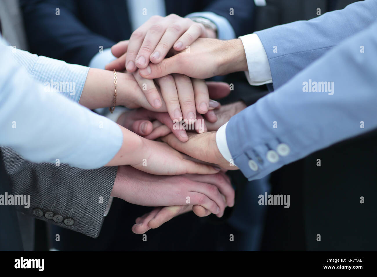 Portrait of a business team joining hands together in office Stock ...