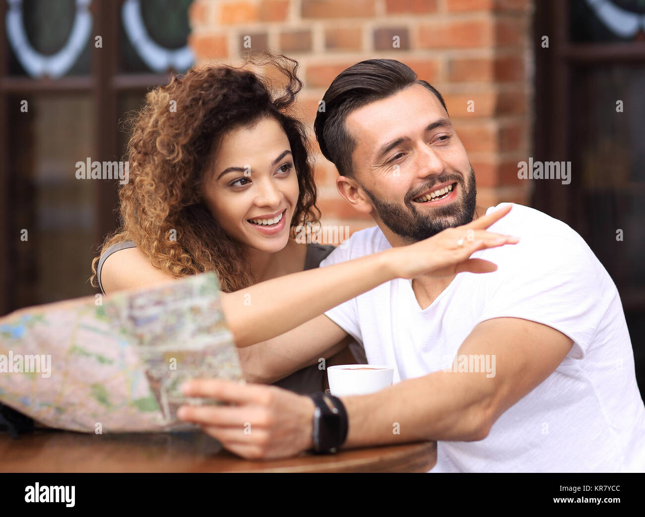 A picture of tourists looking at map in a cafe Stock Photo - Alamy
