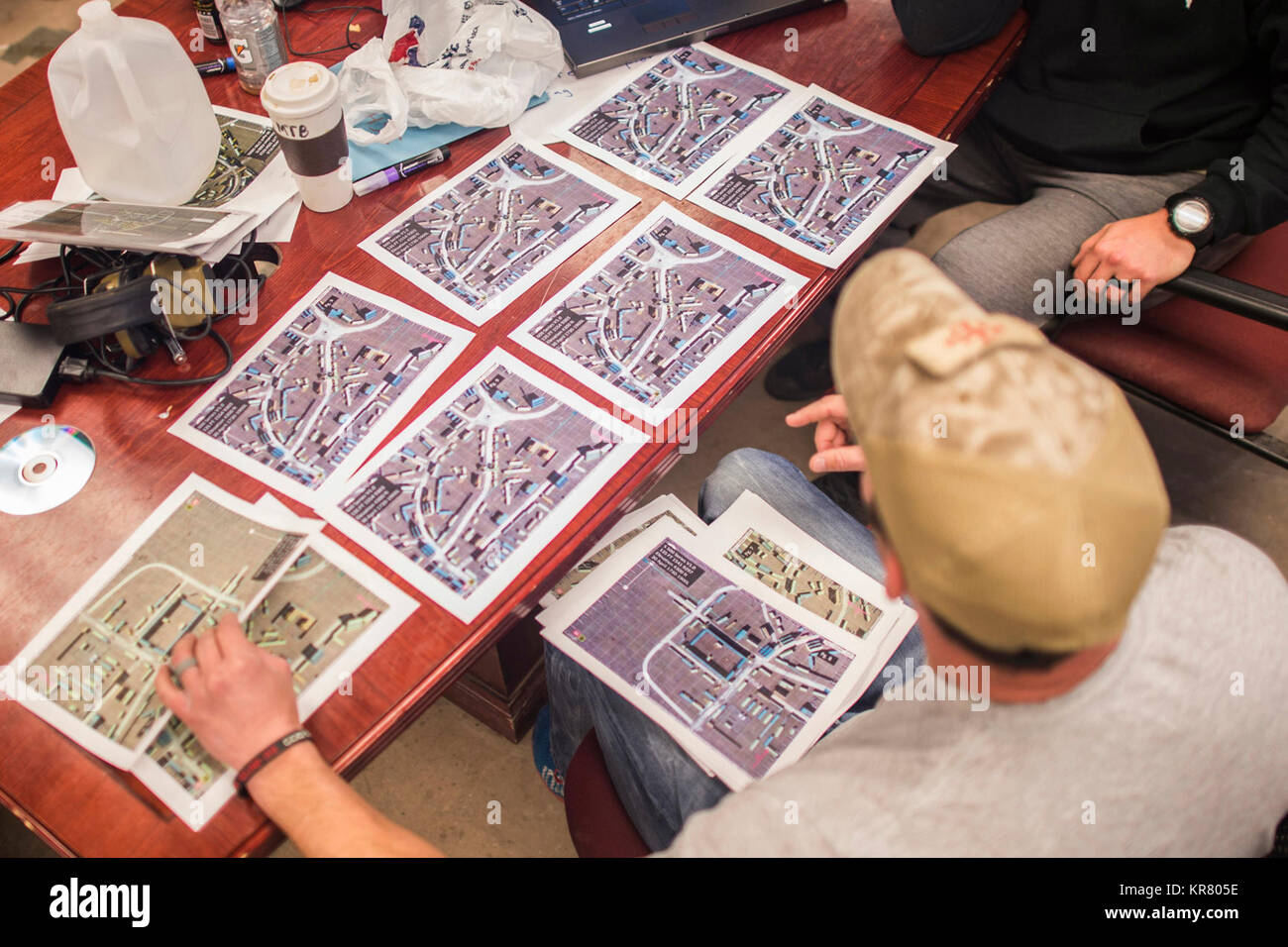 Members of the U.S. military and Clovis SWAT team look over maps during ...