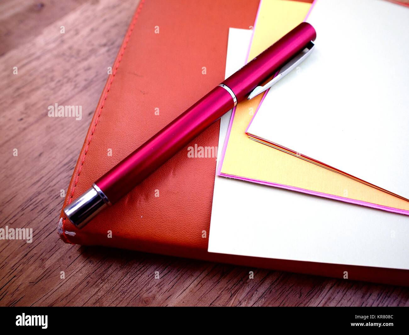 Photo of pen, notebook and colored papers Stock Photo - Alamy