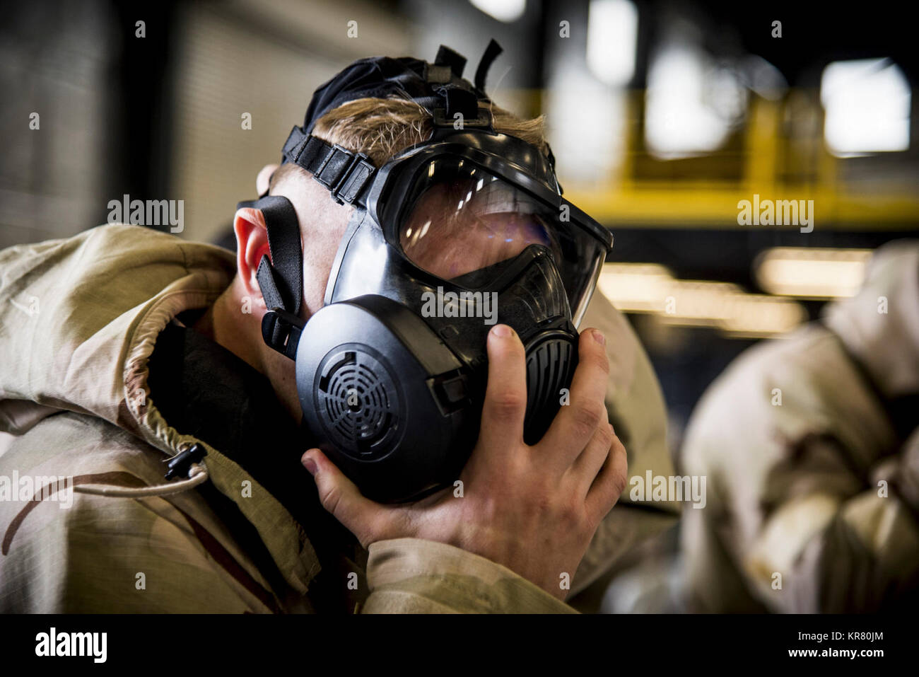 An Airman assigned to the 512th Airlift Wing dons a M50 gas mask during ...