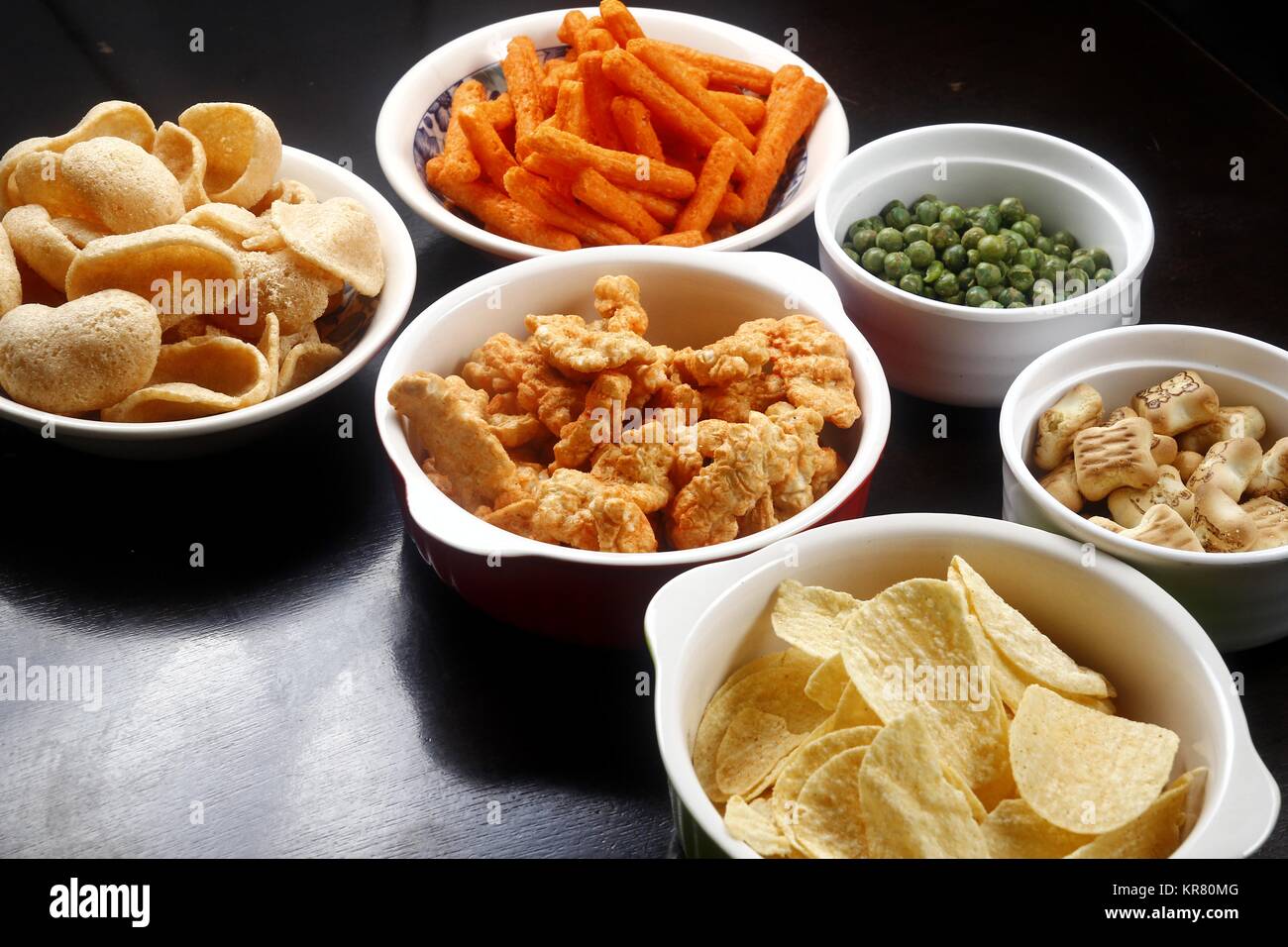 Photo of assorted chips and junk food in bowls Stock Photo - Alamy