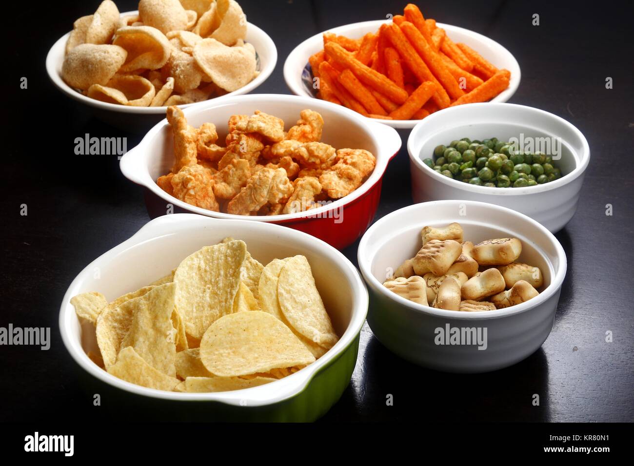 Photo of assorted chips and junk food in bowls Stock Photo - Alamy