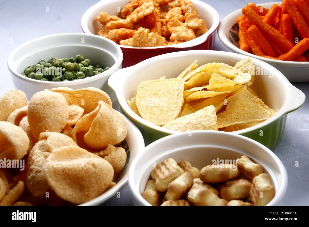 Photo of assorted chips and junk food in bowls Stock Photo - Alamy