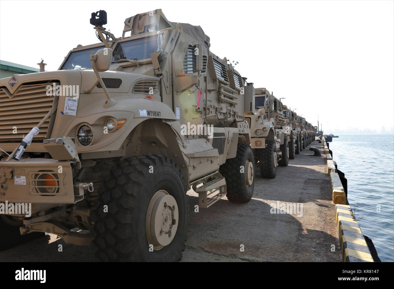 Mine Resistant Ambush Protected vehicles are staged at Pier 8 to be ...