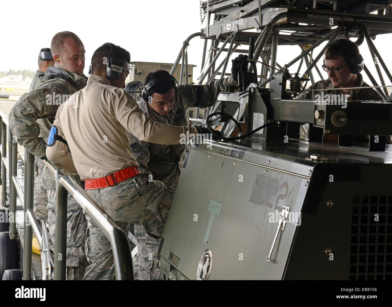 Airmen assigned to the 62nd Aerial Port Squadron prepare to load cargo ...
