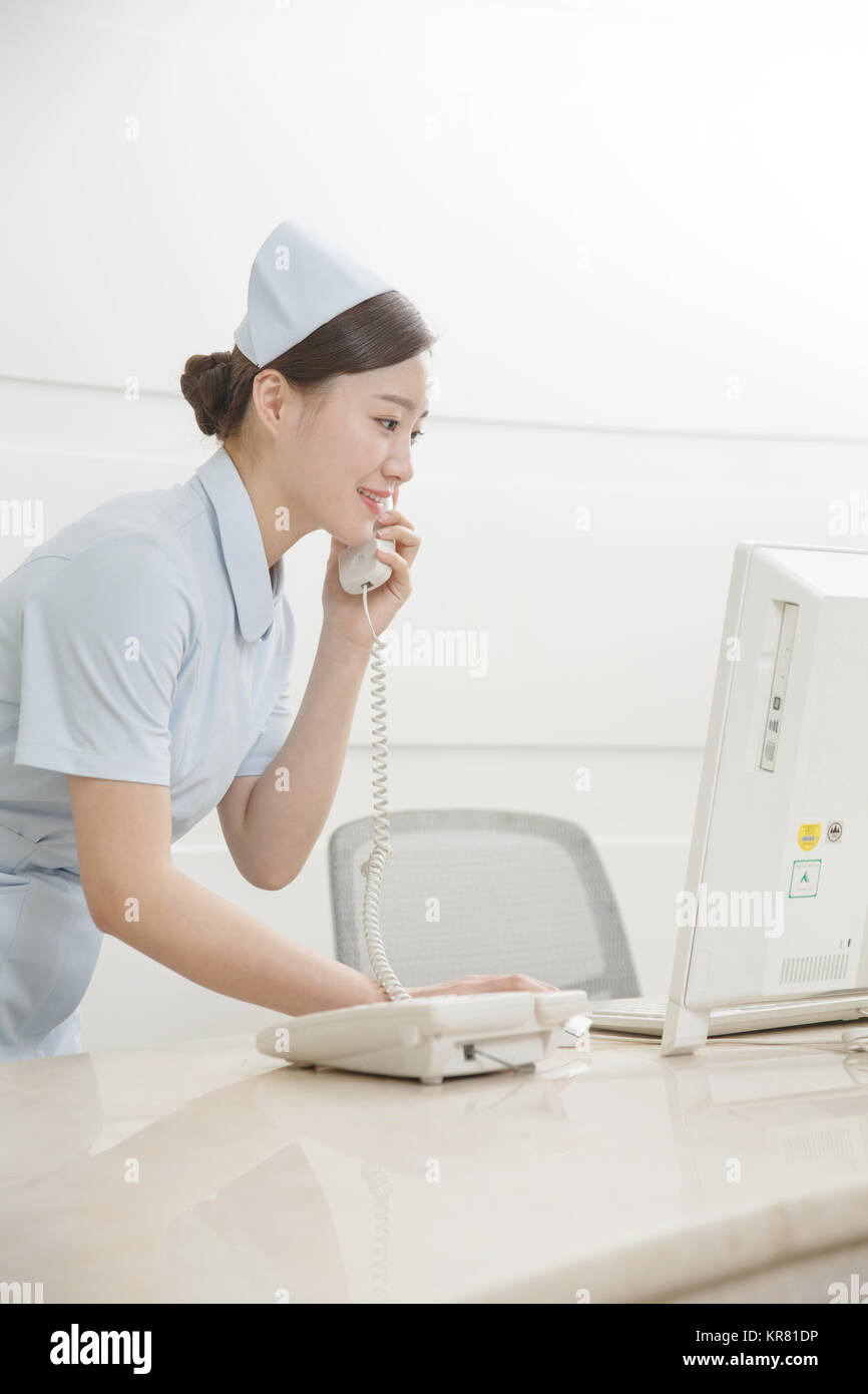 The young woman nurse is on the phone Stock Photo - Alamy