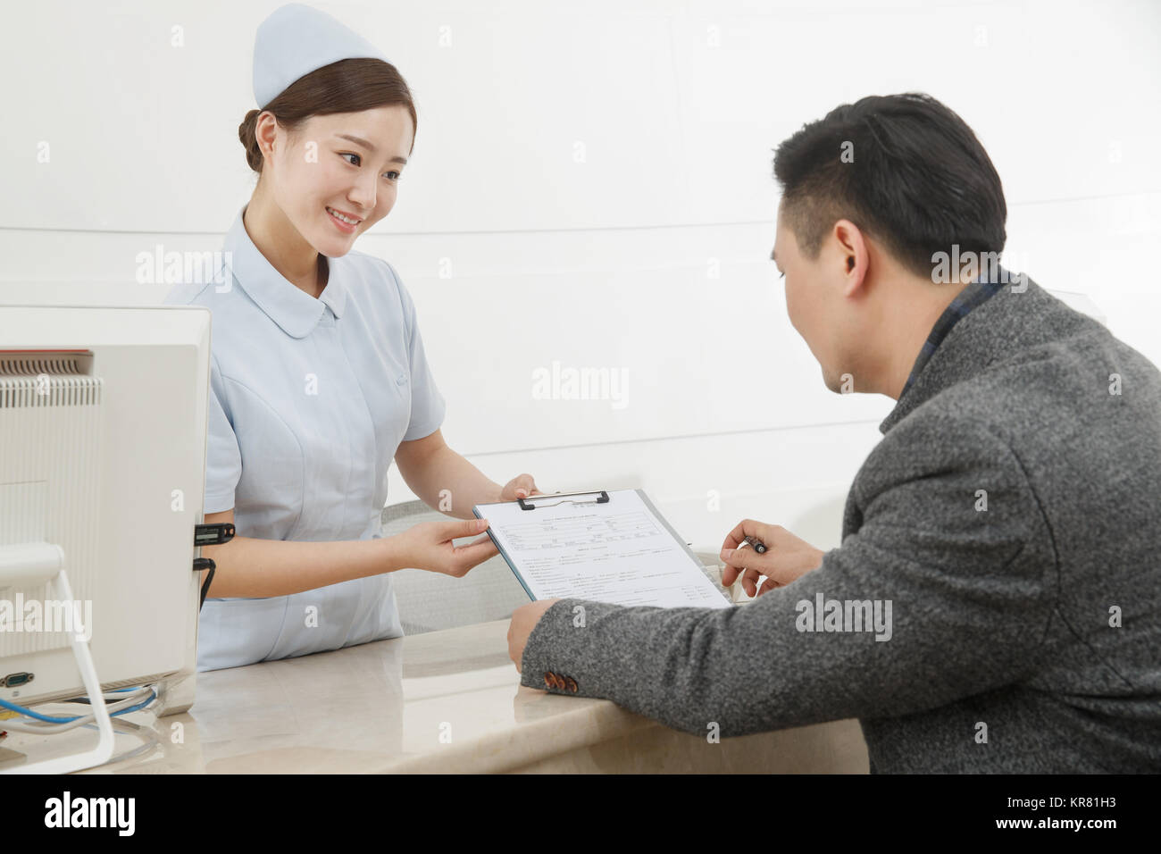 The patient signs at the front desk Stock Photo - Alamy