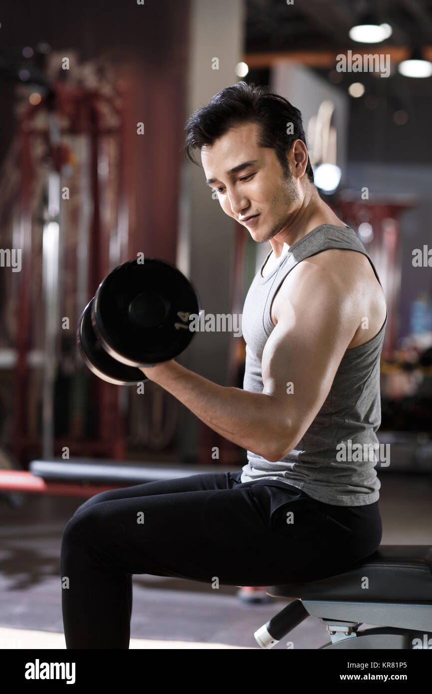 Young men exercise in the gym Stock Photo - Alamy