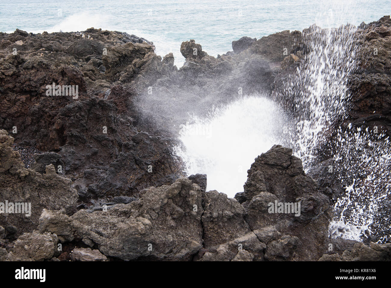 Little blowhole erupting at the volcanic rock beach of La Perouse Bay ...