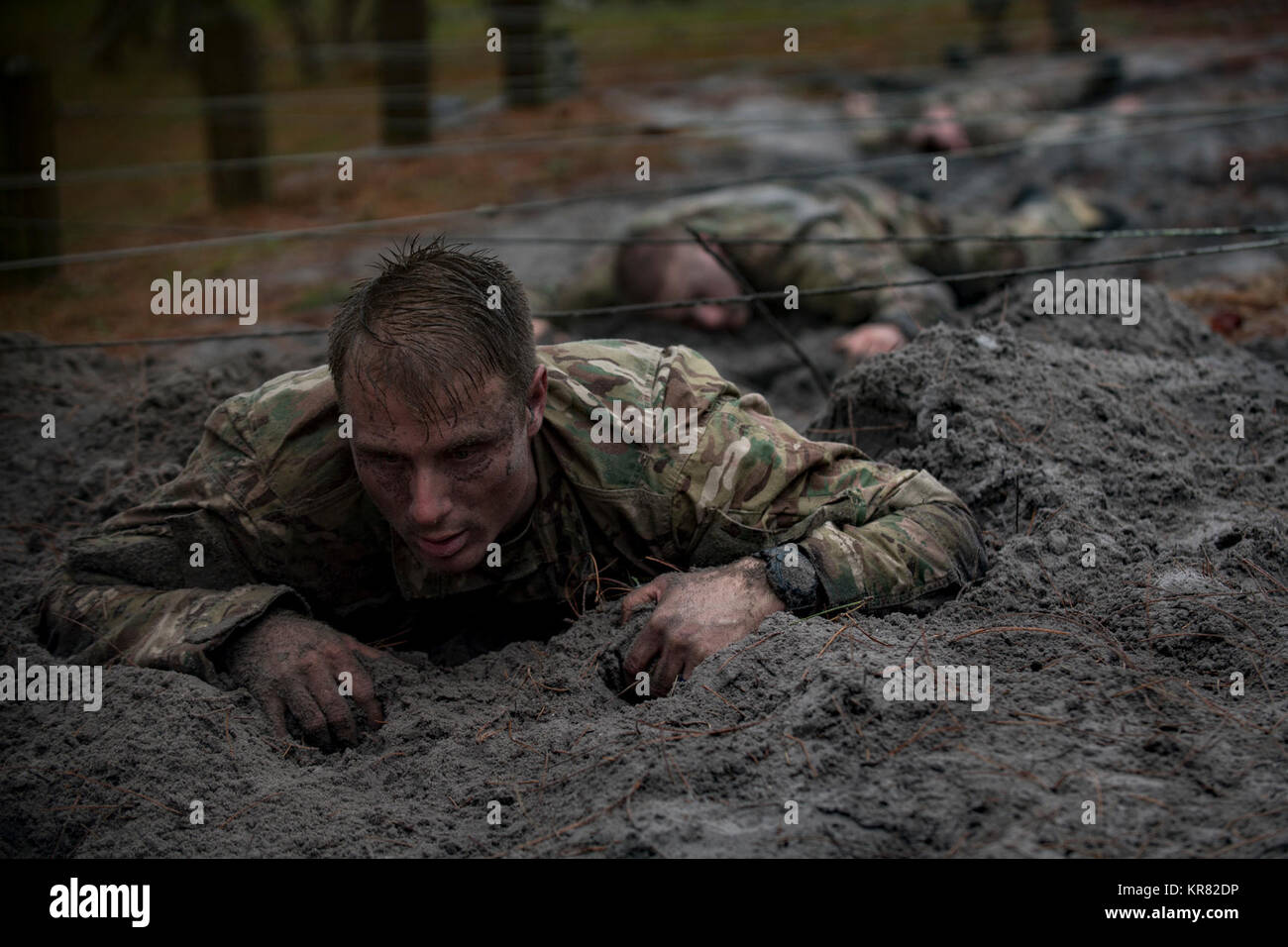 Airmen from the 820th Base Defense Group low crawl through an obstacle ...