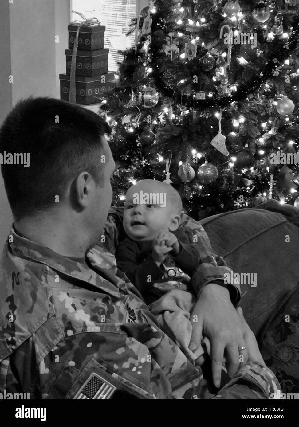William Leasure Jr. lies in the arms of his father, U.S. Army Capt ...