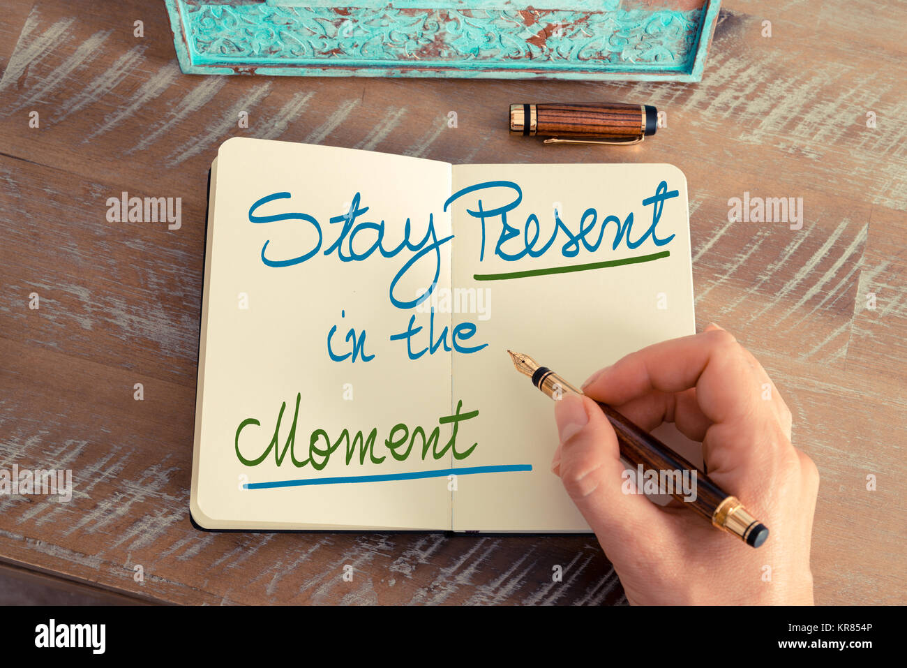 Handwritten text Stay Present in the Moment Stock Photo - Alamy