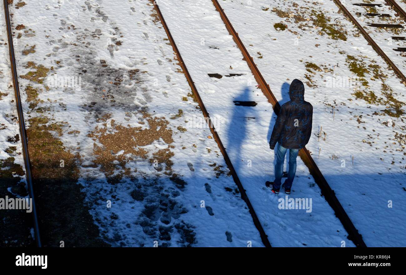 a young man waiting for a train Stock Photo - Alamy