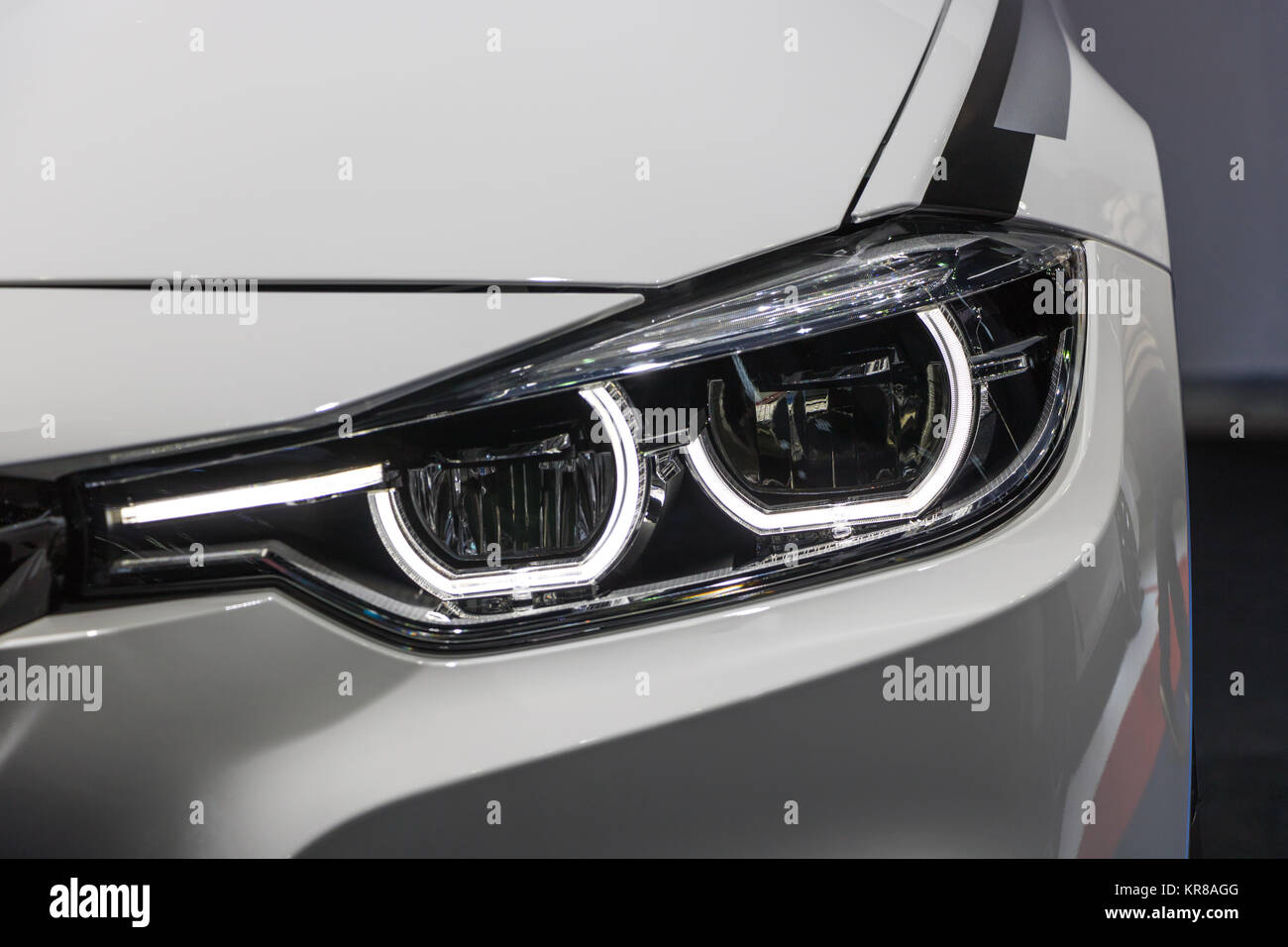 The Closeup Front Headlight car in Motor Show with Light Yellow Stock ...