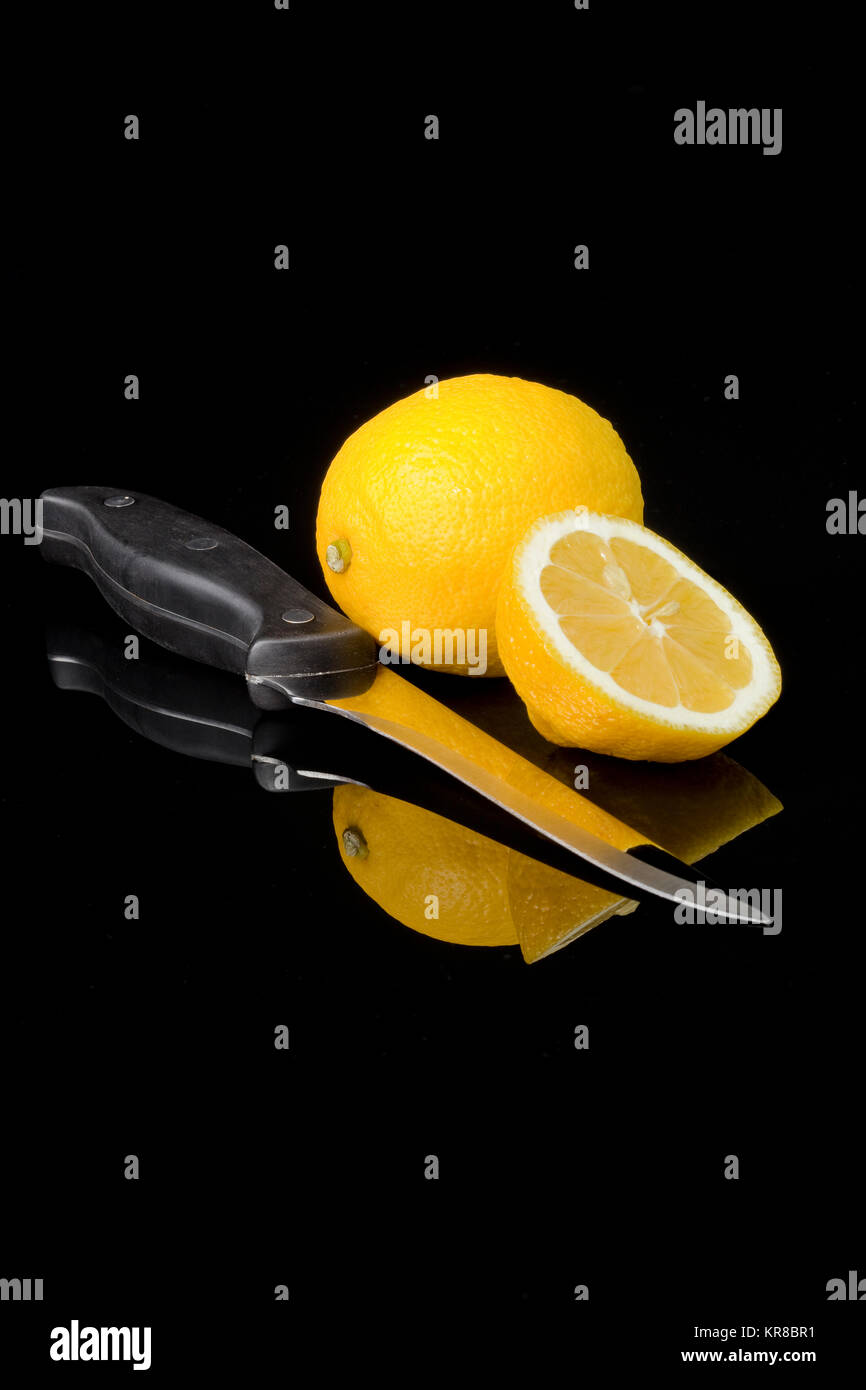 lemon and kitchen knife with black background Stock Photo - Alamy