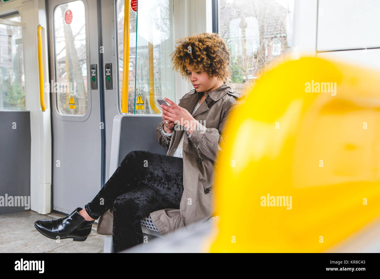 Texting on the train Stock Photo - Alamy