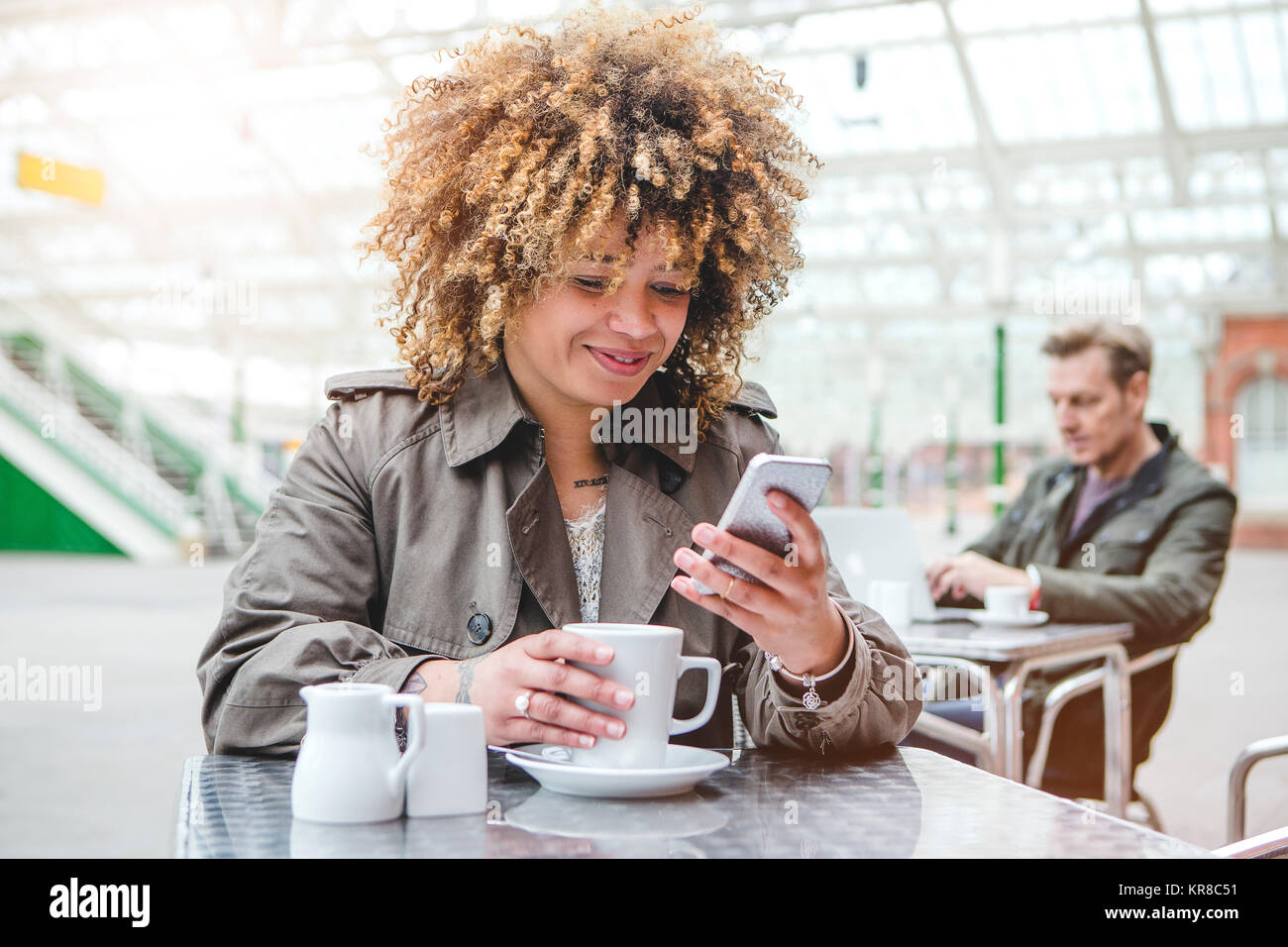 Enjoying a coffee while I wait Stock Photo - Alamy