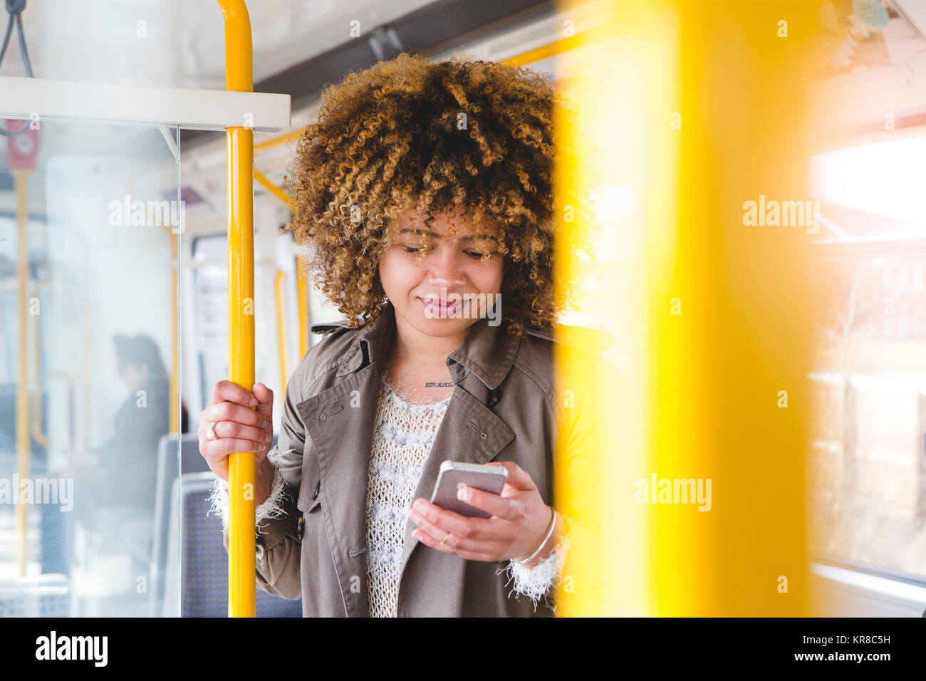 Texting on the train Stock Photo - Alamy
