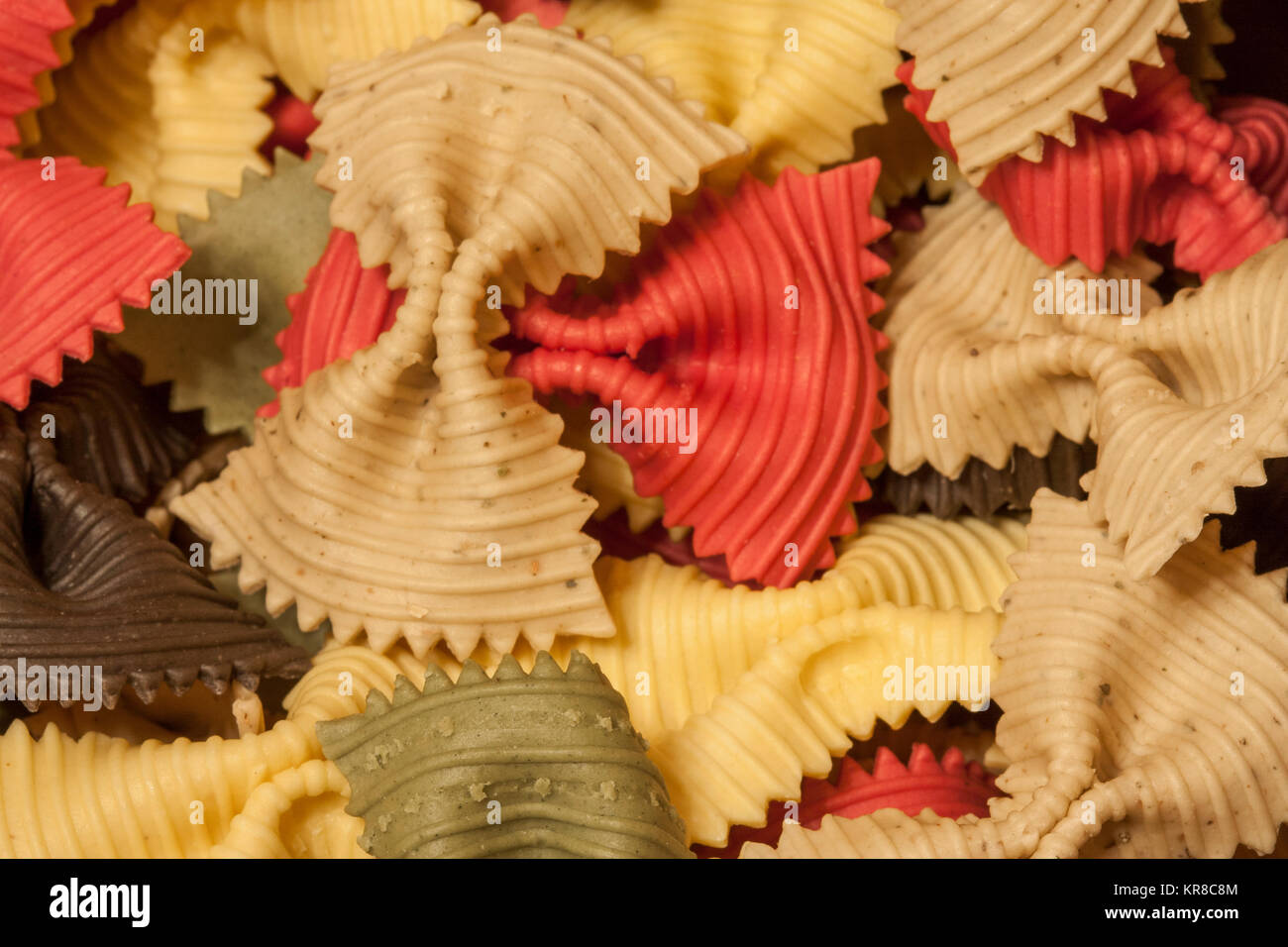 background of multicolored macaroni figured as bow Stock Photo - Alamy