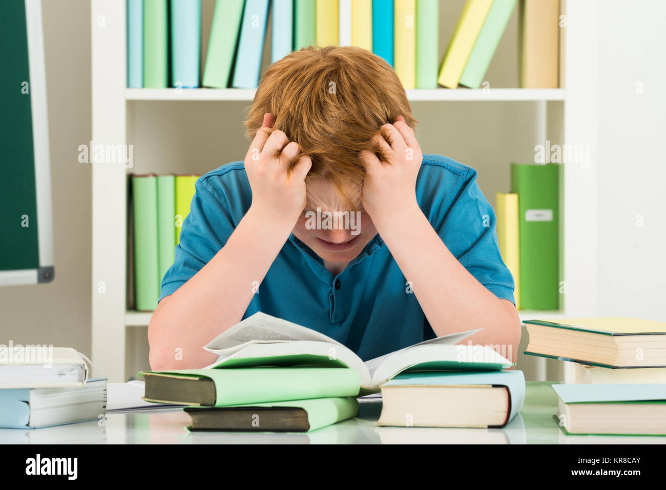 Exhausted Boy Studying In Library Stock Photo - Alamy