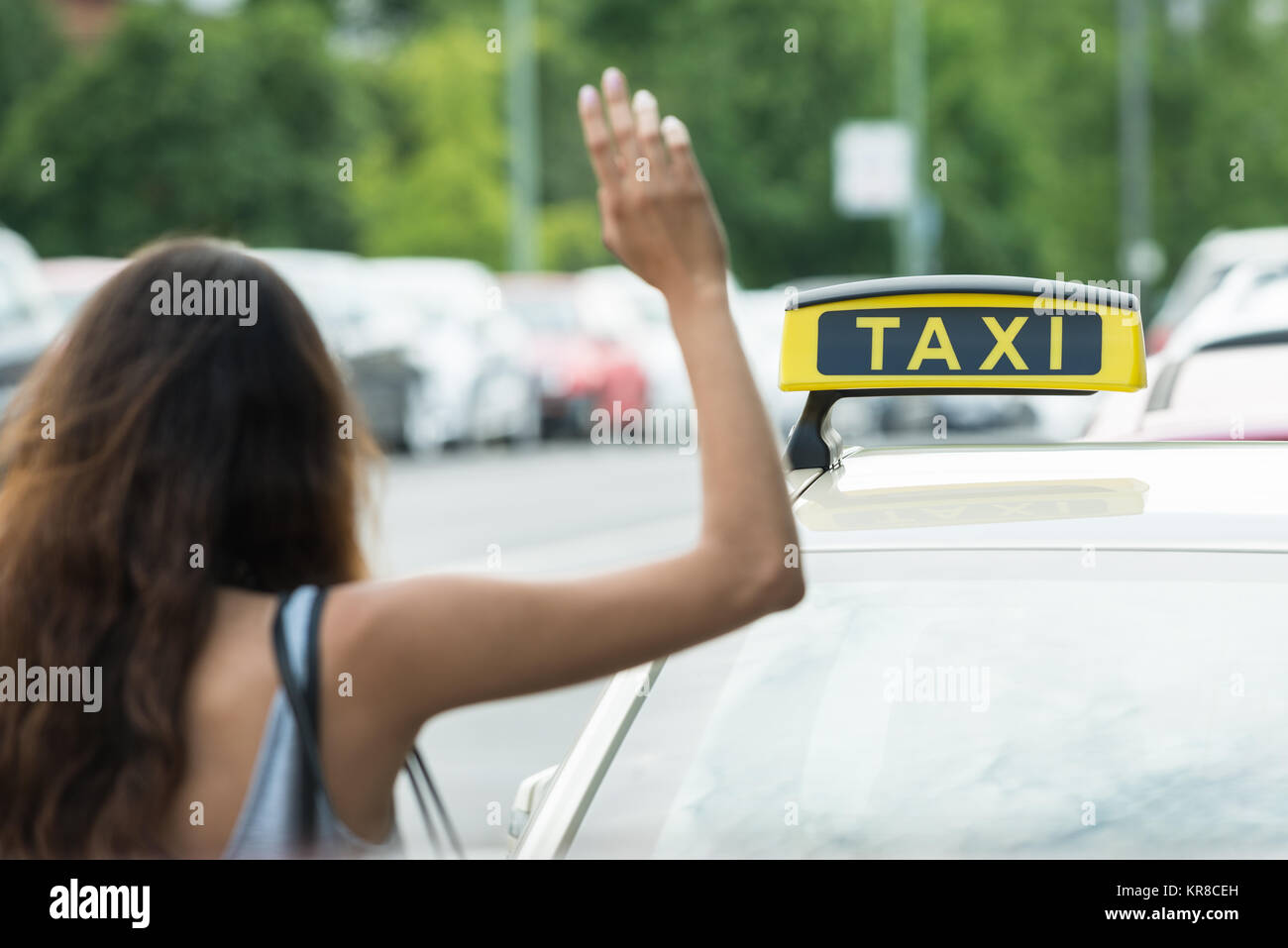 Woman Calling For Taxi Stock Photo - Alamy