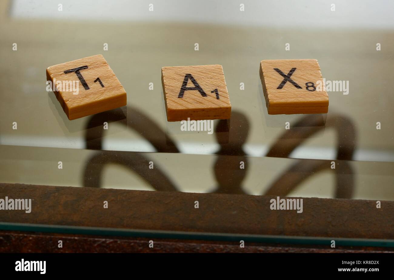 word TAX written in scrabble tiles on a piece of glass Stock Photo - Alamy