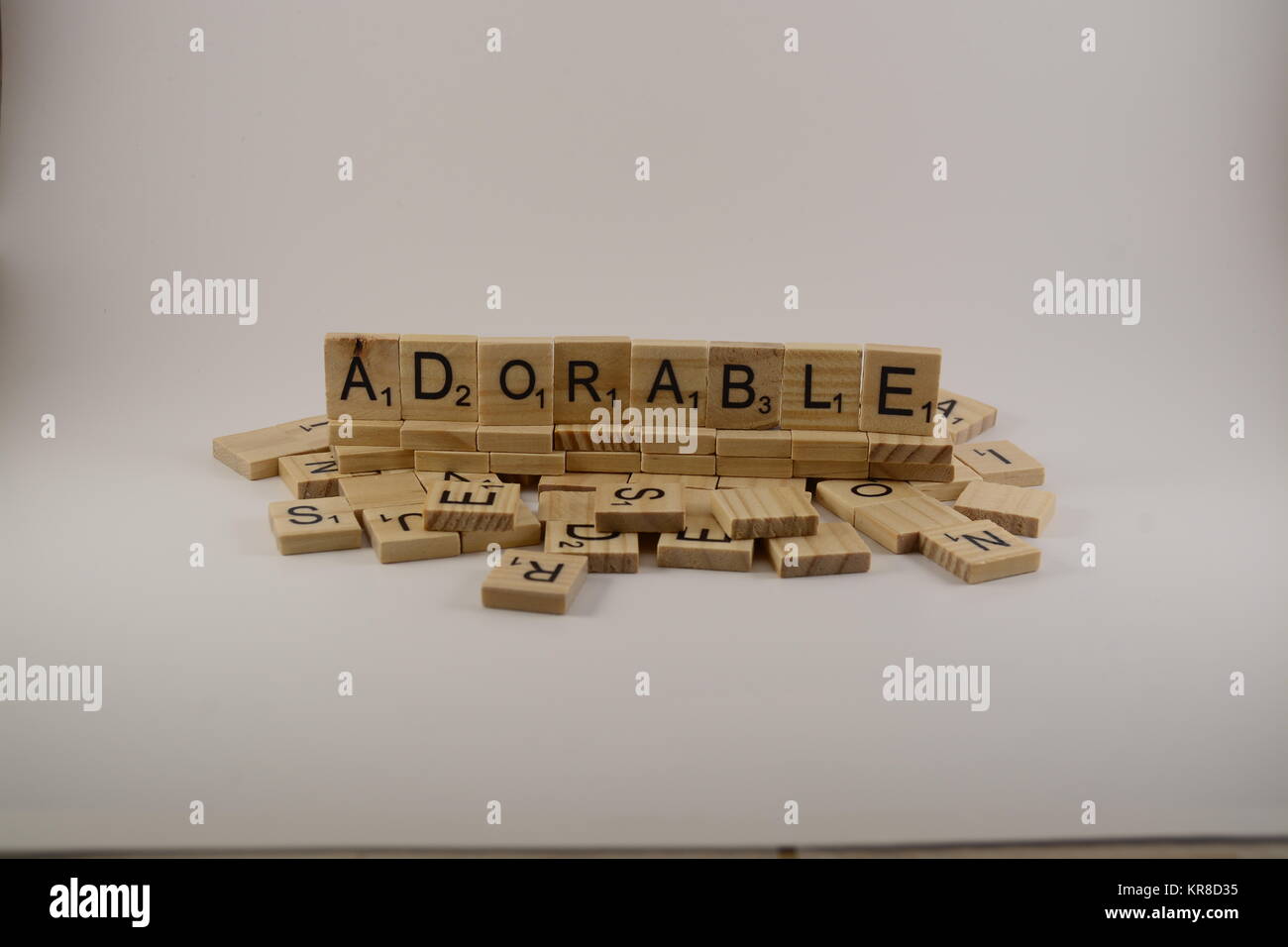 word Adorable written in scrabble tiles Stock Photo - Alamy
