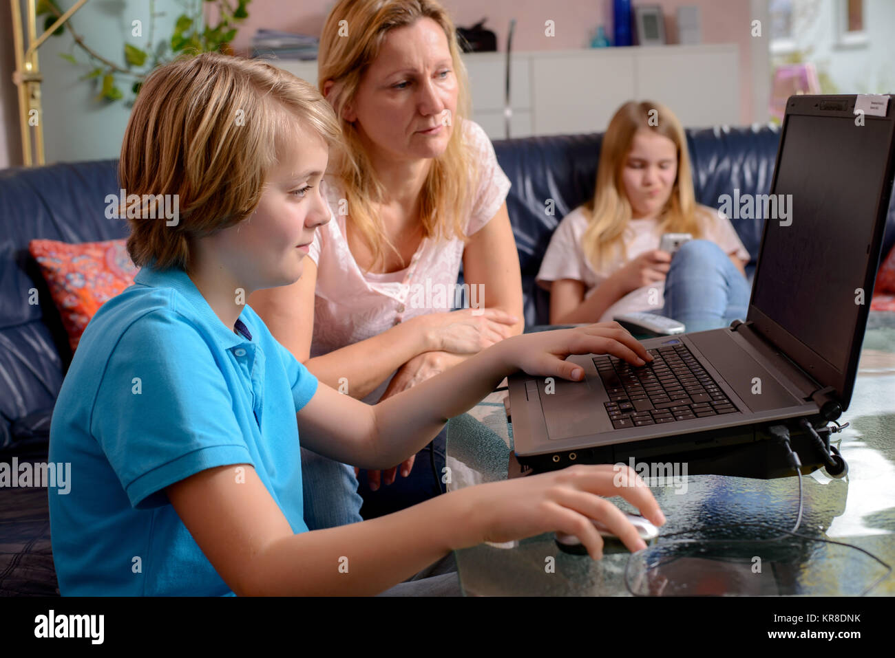 blond mother and her children using computer together Stock Photo - Alamy
