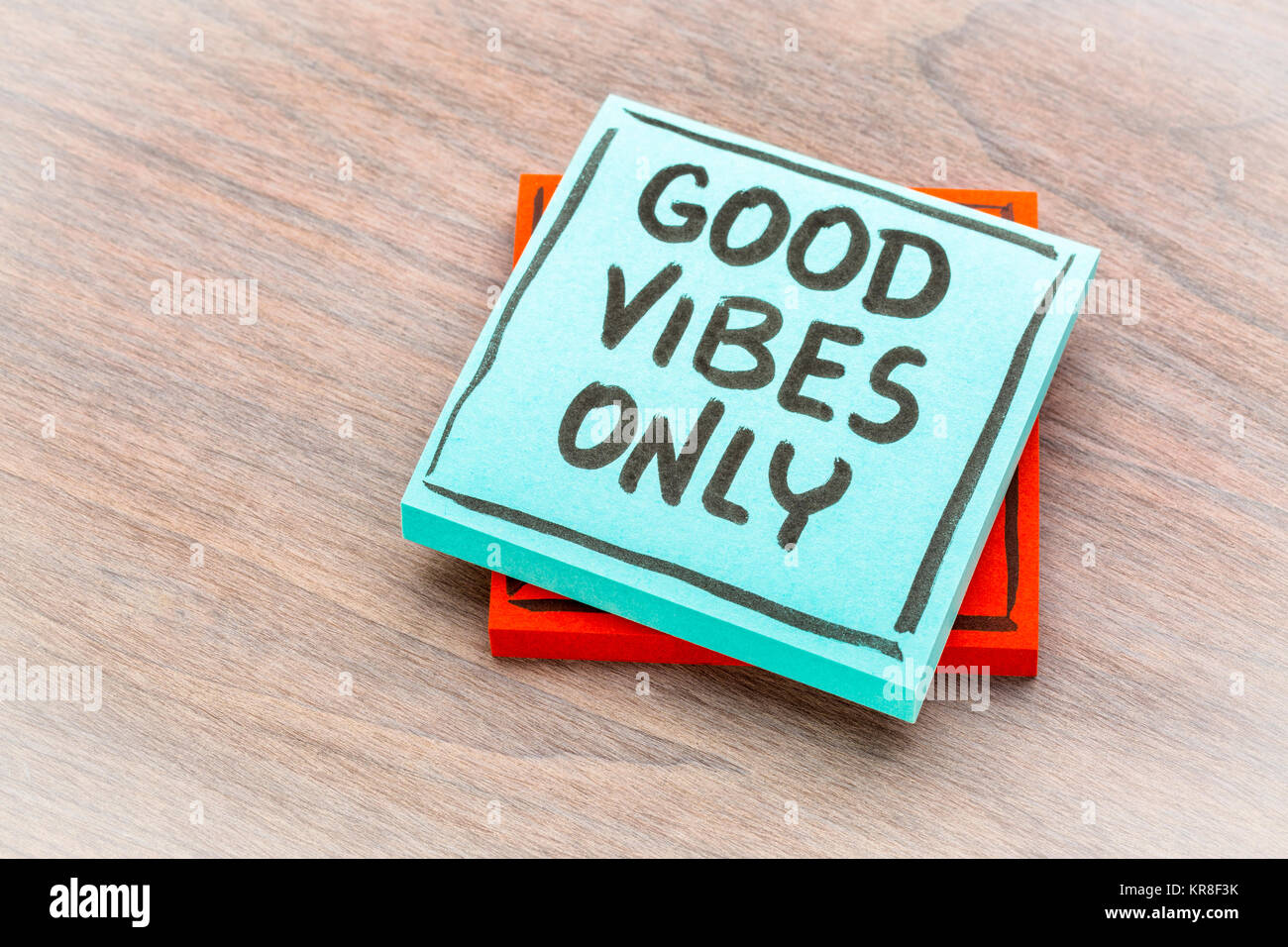 Good vibes only reminder - handwriting on a sticky note against grained ...