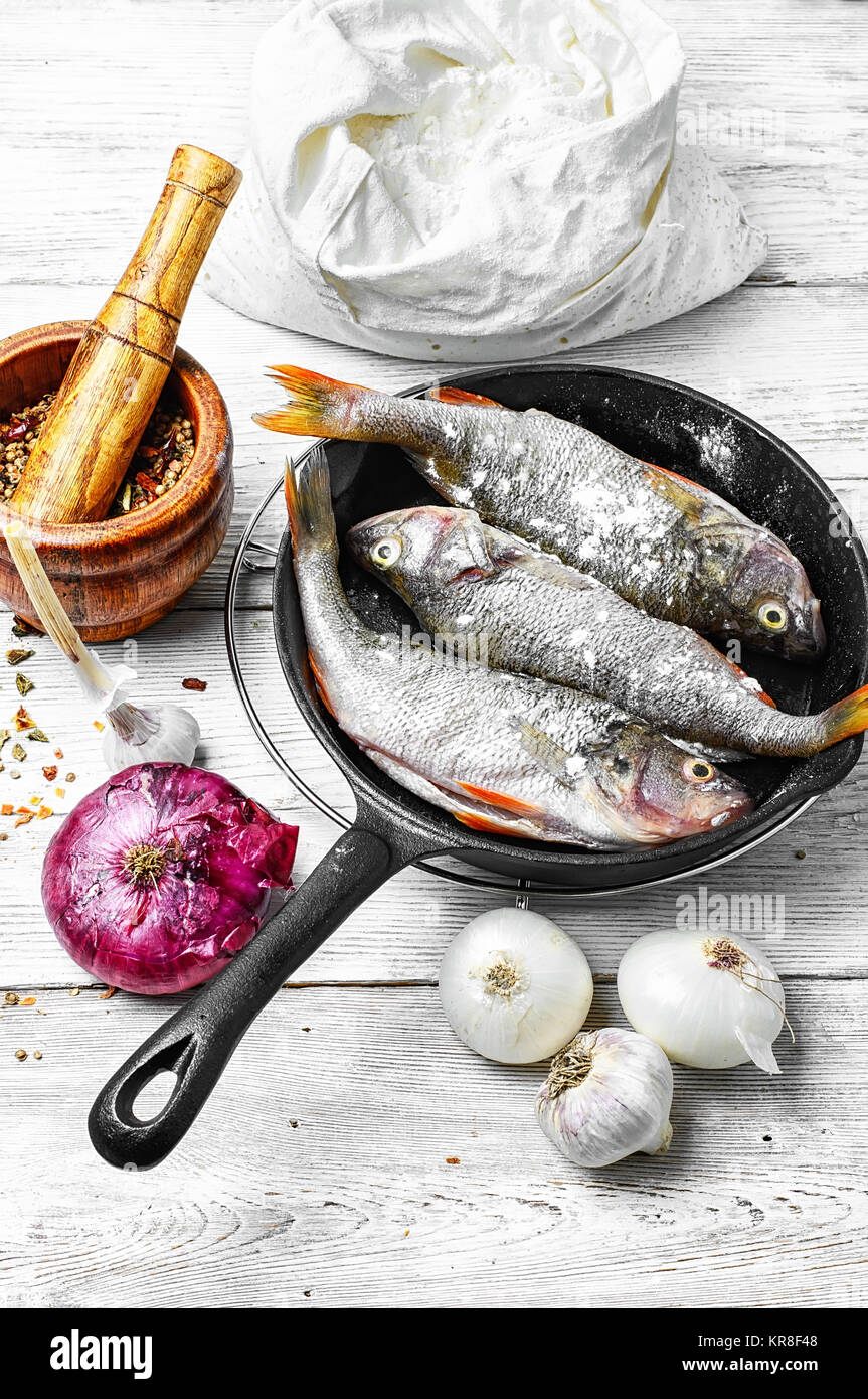 Purified fish on cooking pan and spices Stock Photo - Alamy