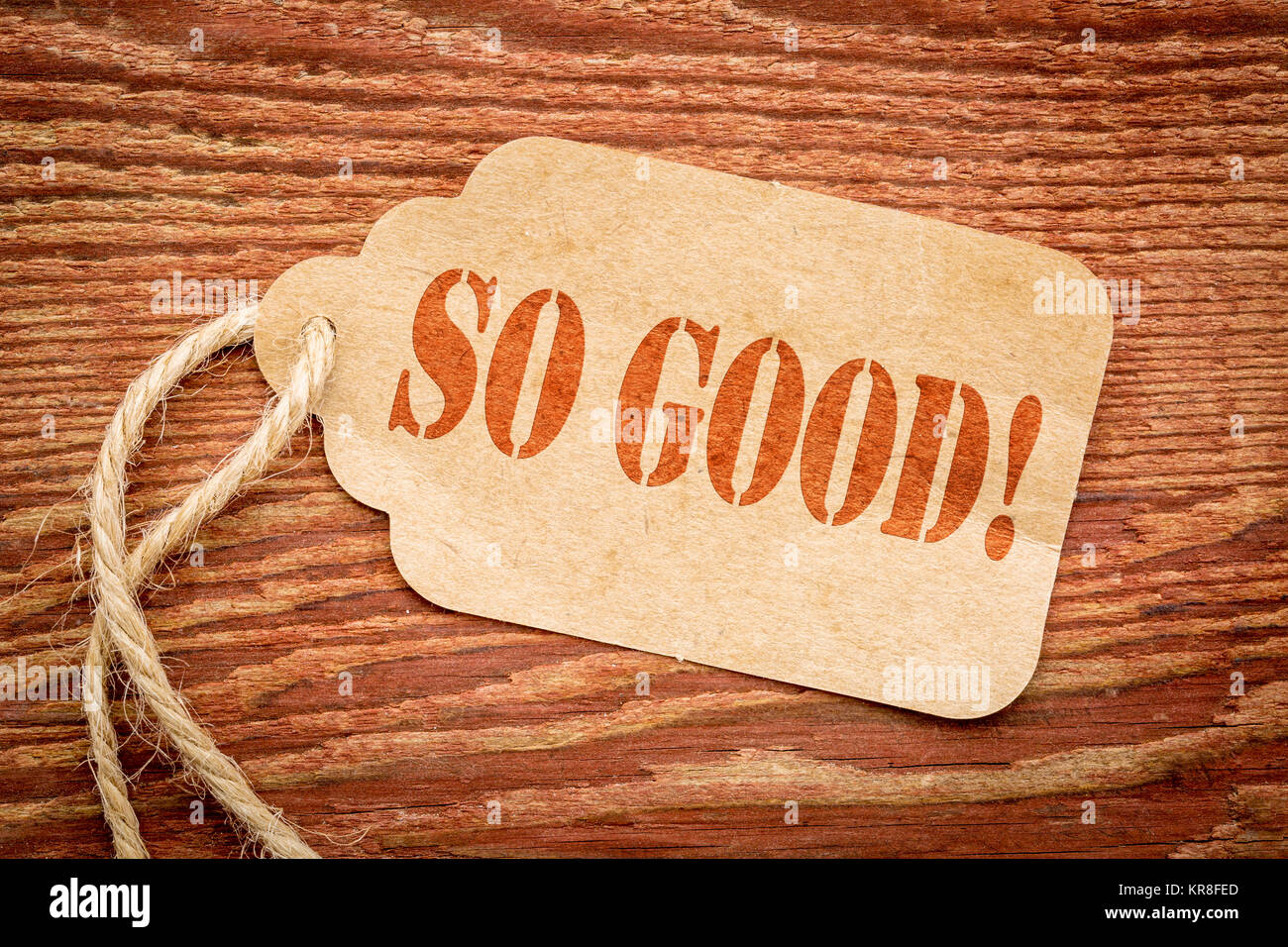 So good sign - red stencil text on a cardboard price tag against rustic ...