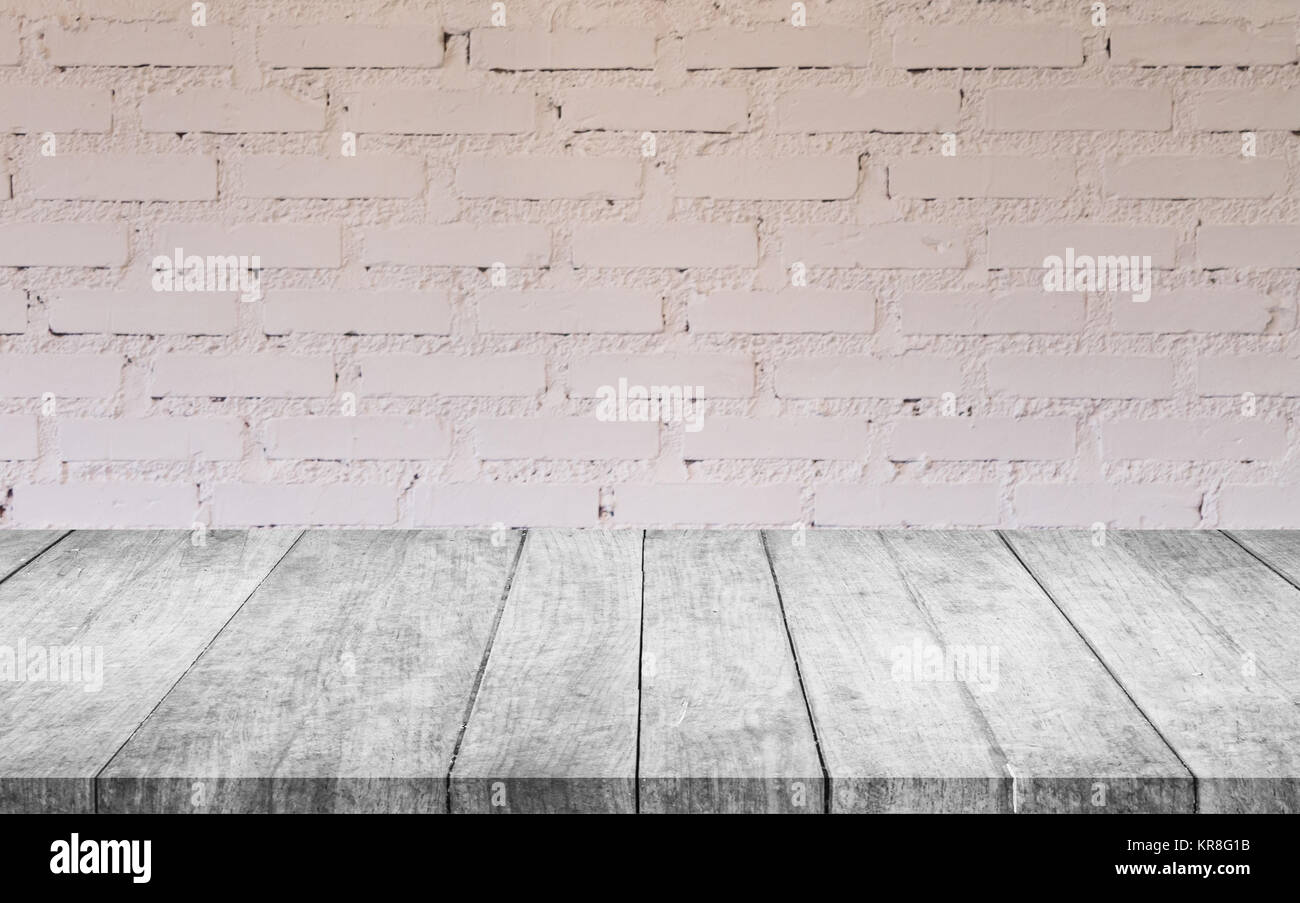 Black and white wooden table top with white brick wall Stock Photo - Alamy