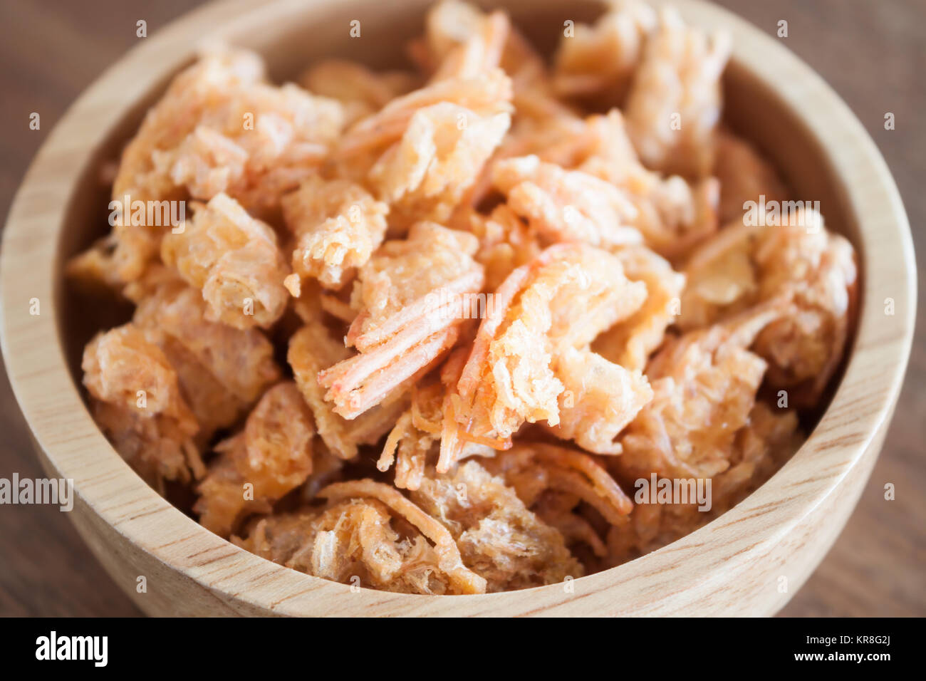 Fried shrimp chins snack in wooden bowl Stock Photo - Alamy