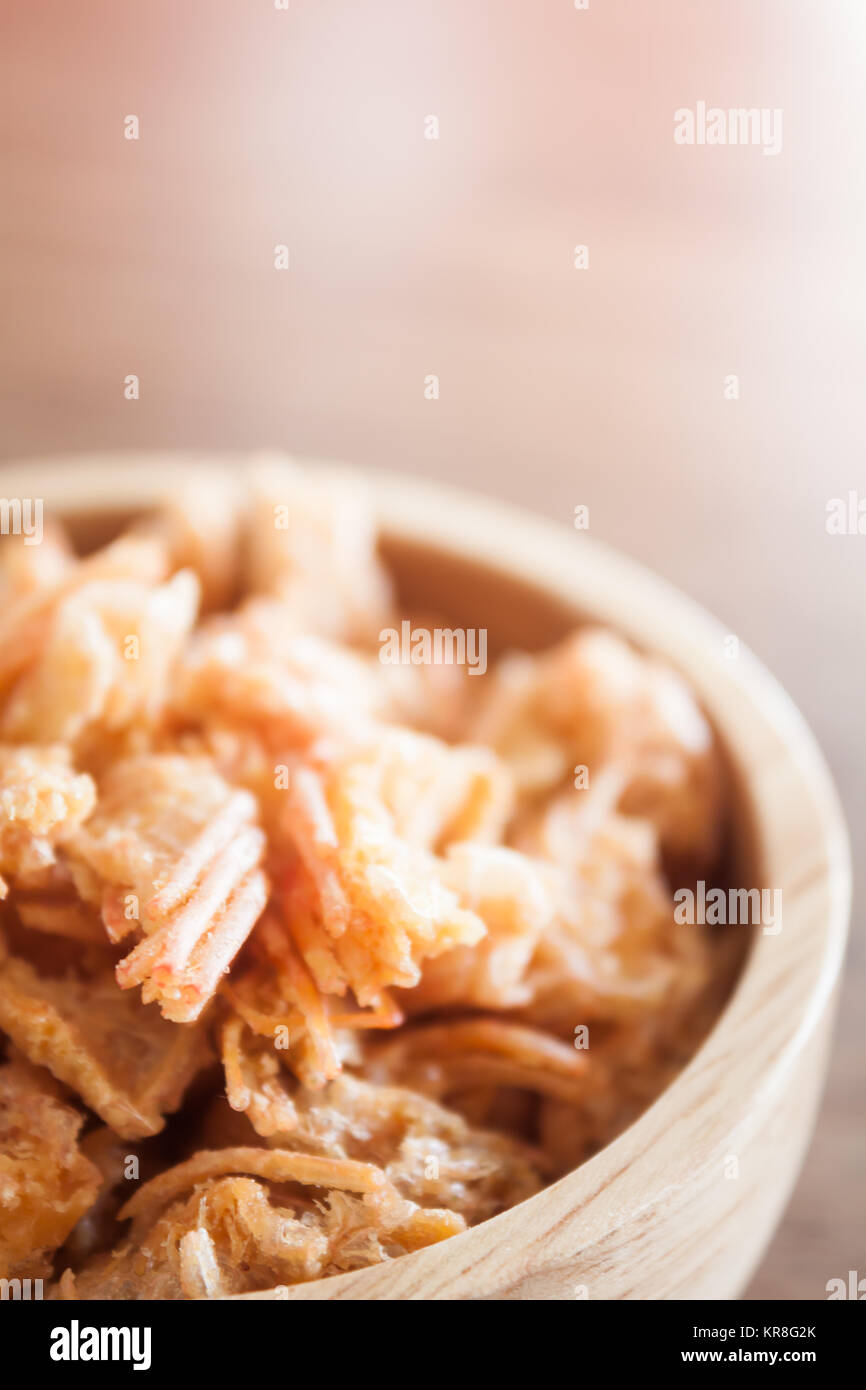 Fried shrimp chins snack in wooden bowl Stock Photo - Alamy