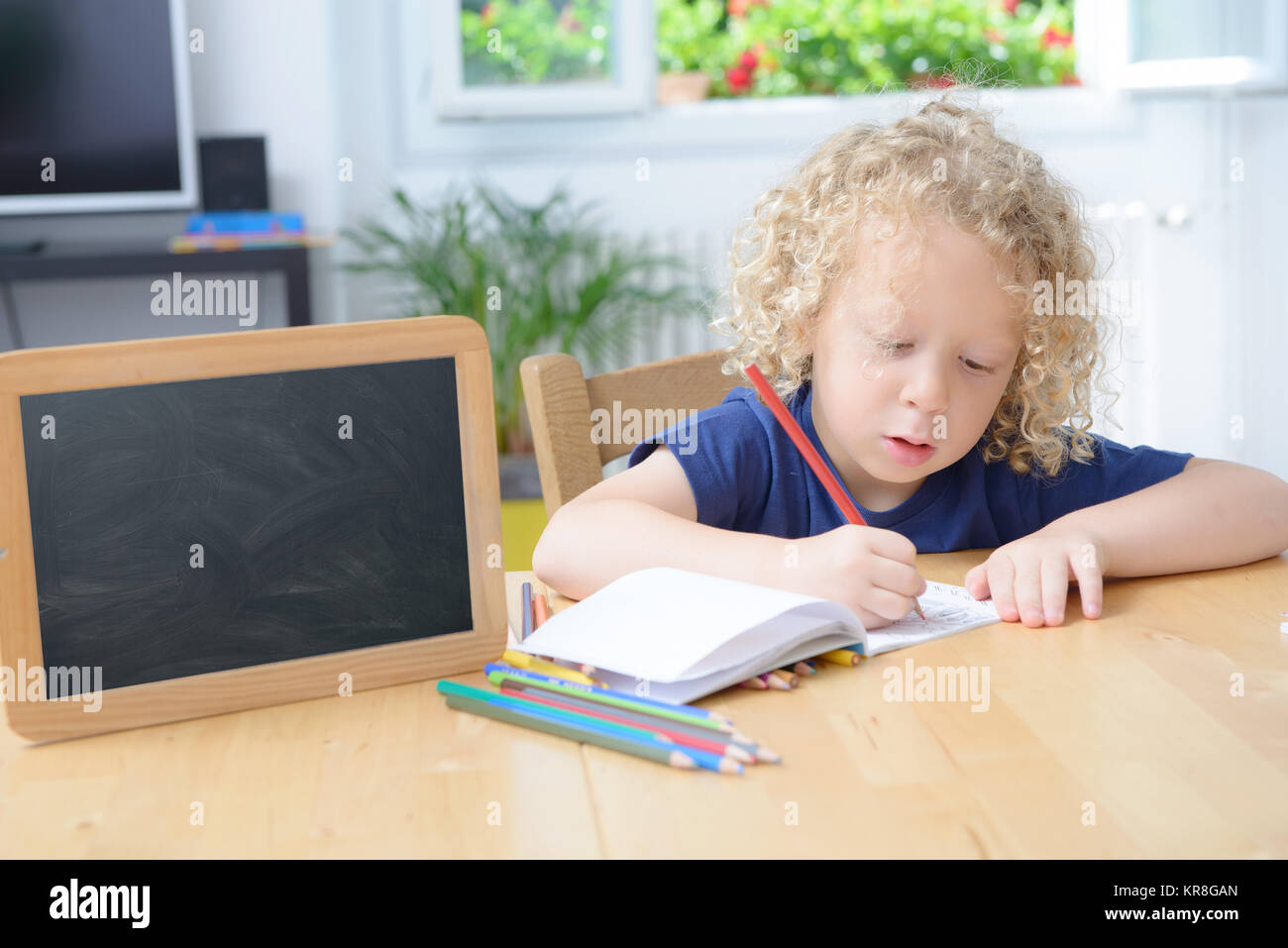 boy drawing on a notebook Stock Photo - Alamy