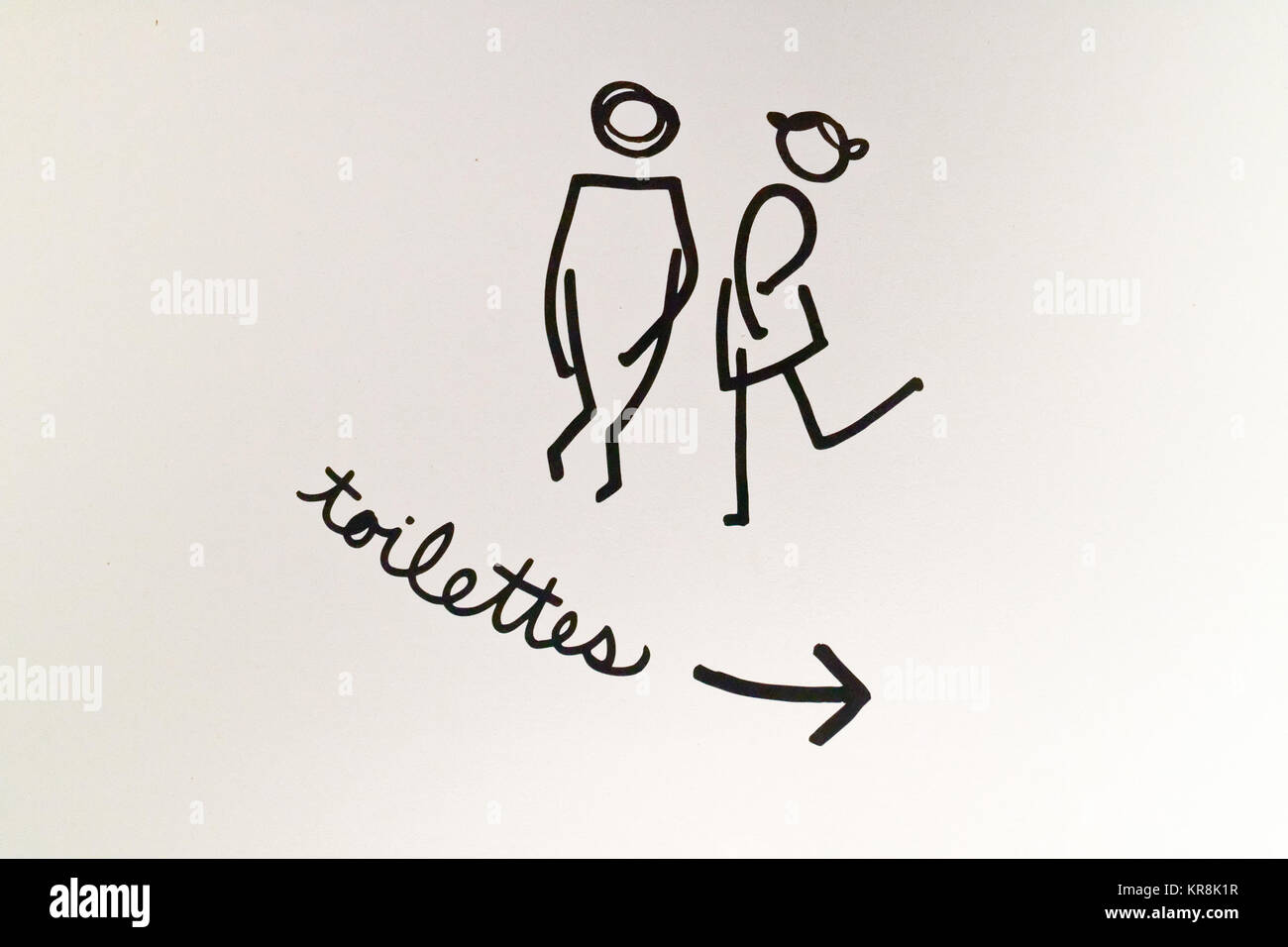 Humourous toilet sign showing a man and a woman, legs crossed, needing ...