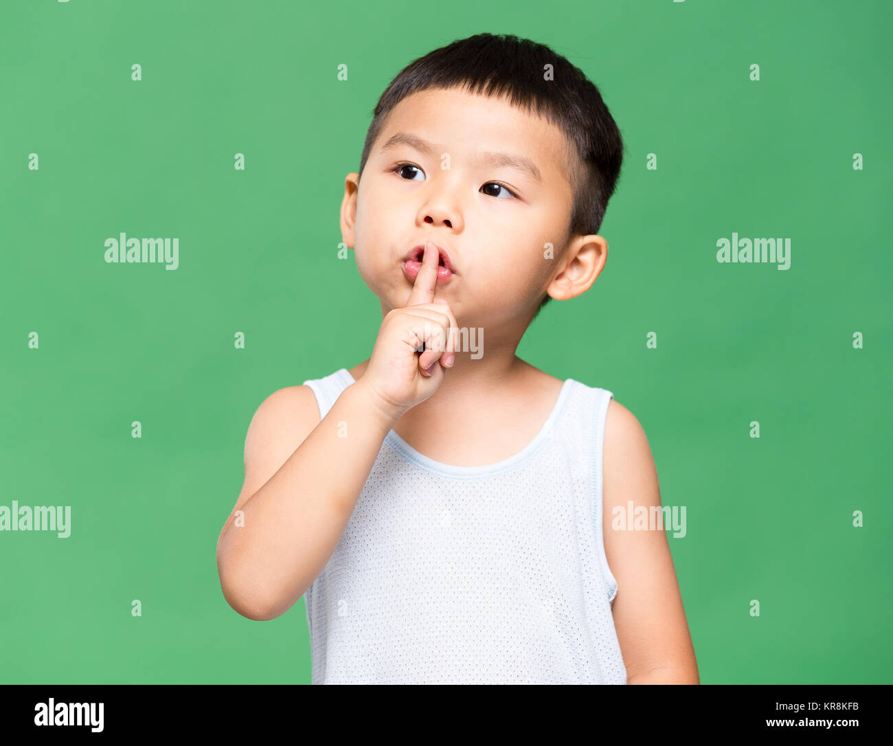 Little boy putting a finger on lips Stock Photo - Alamy