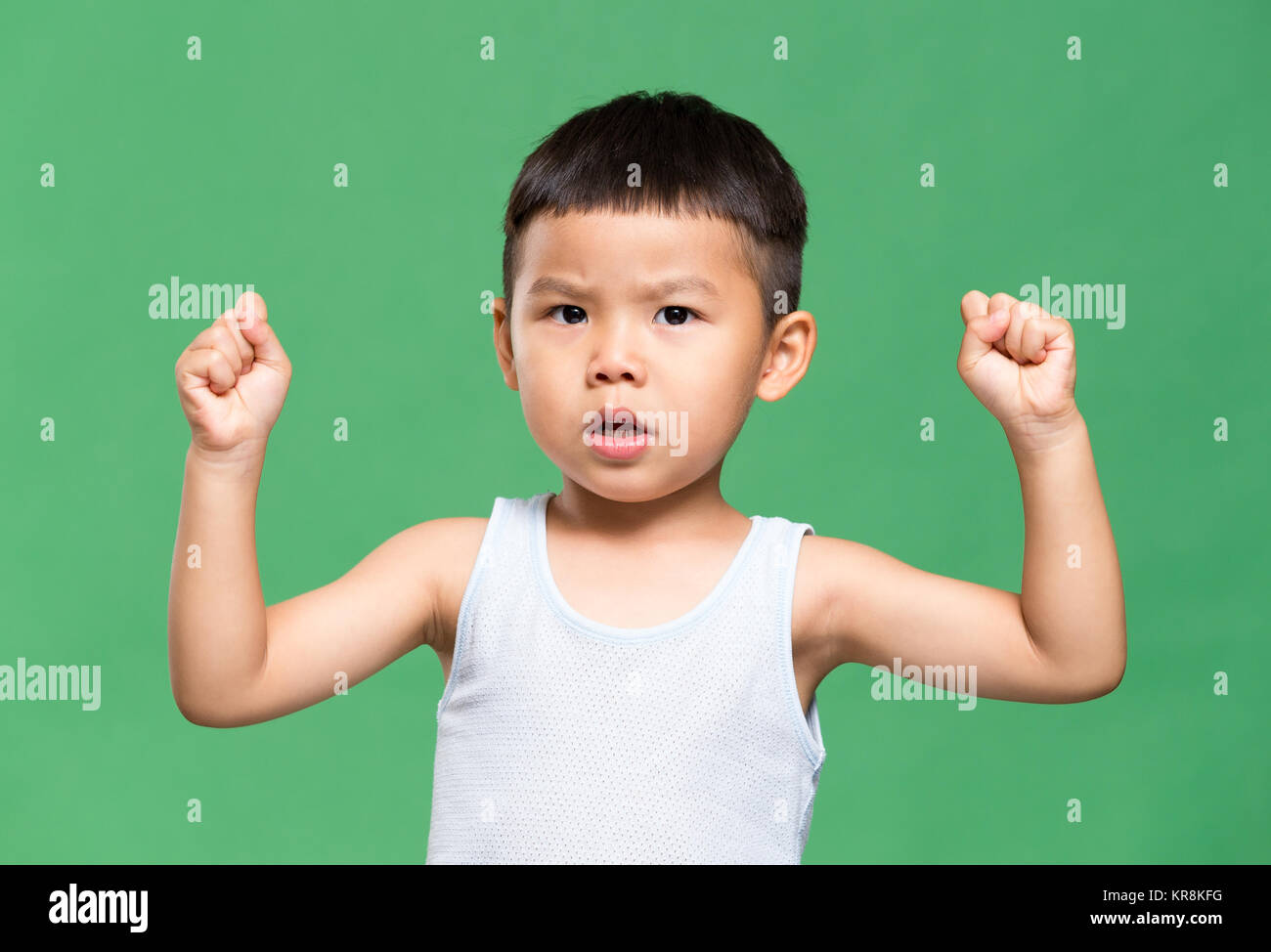 Little boy making a stronger pose Stock Photo - Alamy