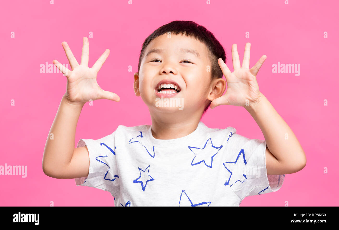 Excited little boy showing grimace Stock Photo - Alamy