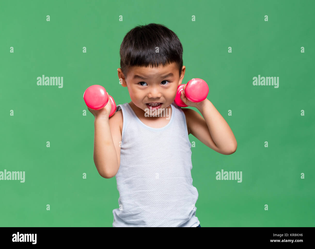 Little boy lifting up dumbbells Stock Photo - Alamy