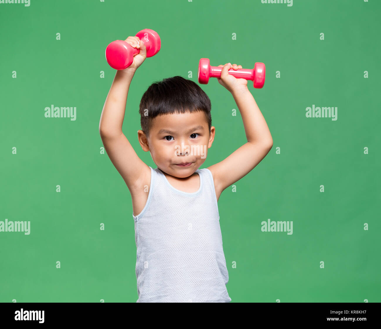 Little boy lifting up dumbbells Stock Photo - Alamy