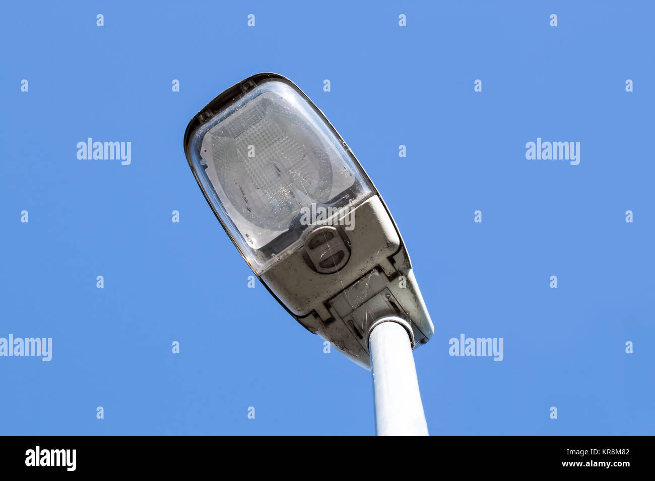 verdreckte street lamp in front of a bright blue sky Stock Photo - Alamy