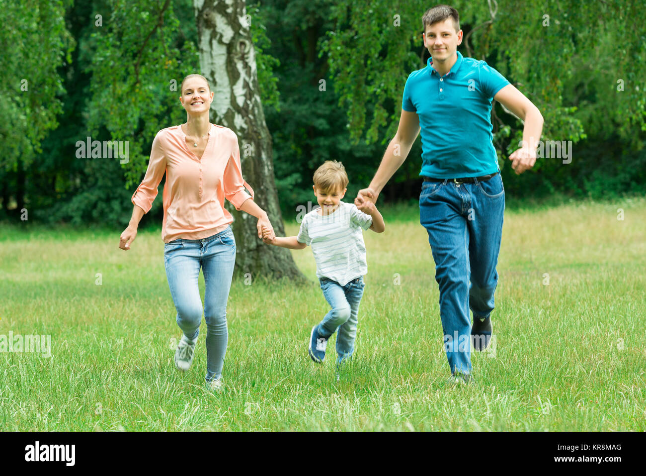 Family Running In The Park Stock Photo - Alamy