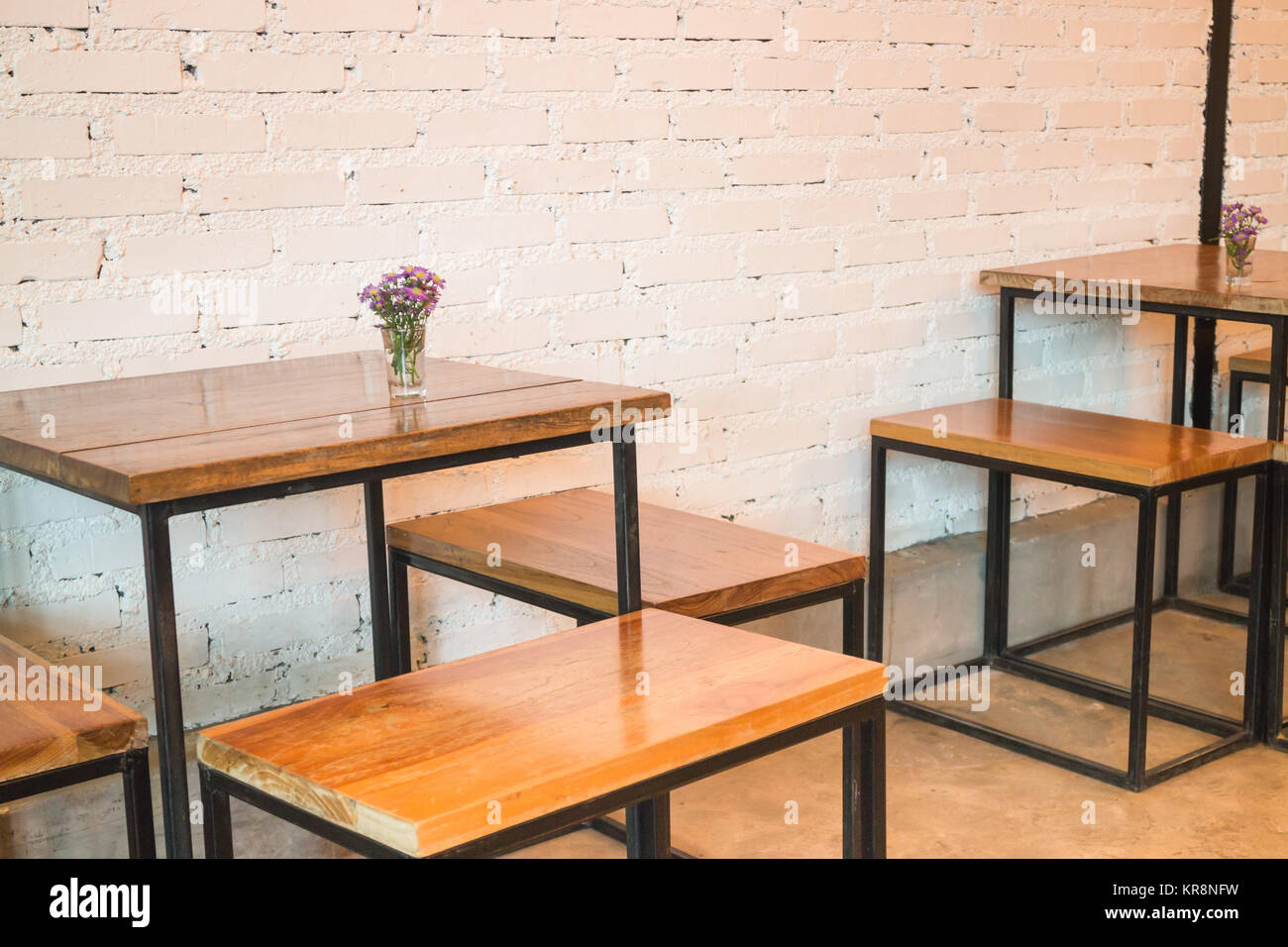 Room interior white brick wall with wooden table Stock Photo - Alamy
