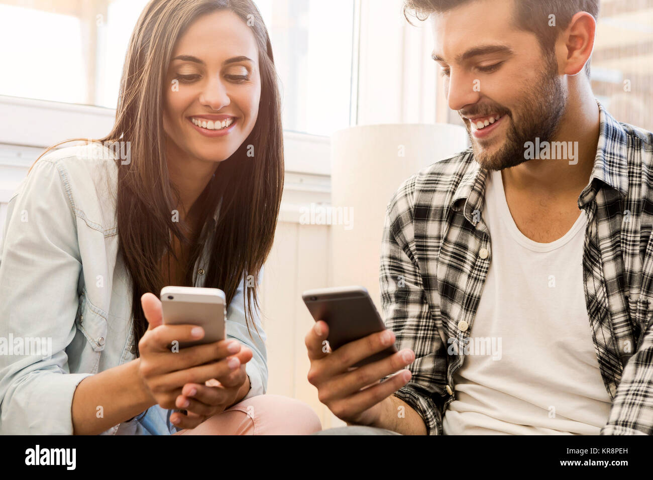 Friends sending a text message Stock Photo - Alamy